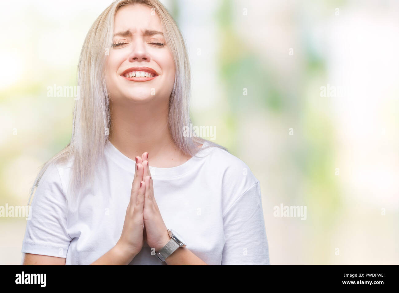Young blonde woman over isolated background begging and praying with ...
