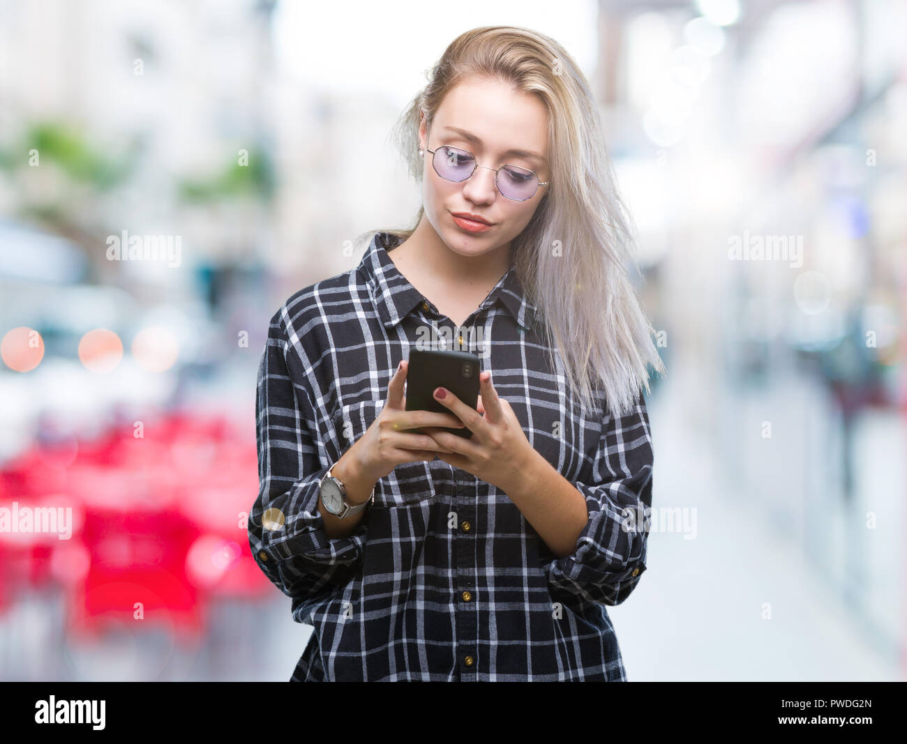 Young blonde woman texting sending message using smartphone over ...