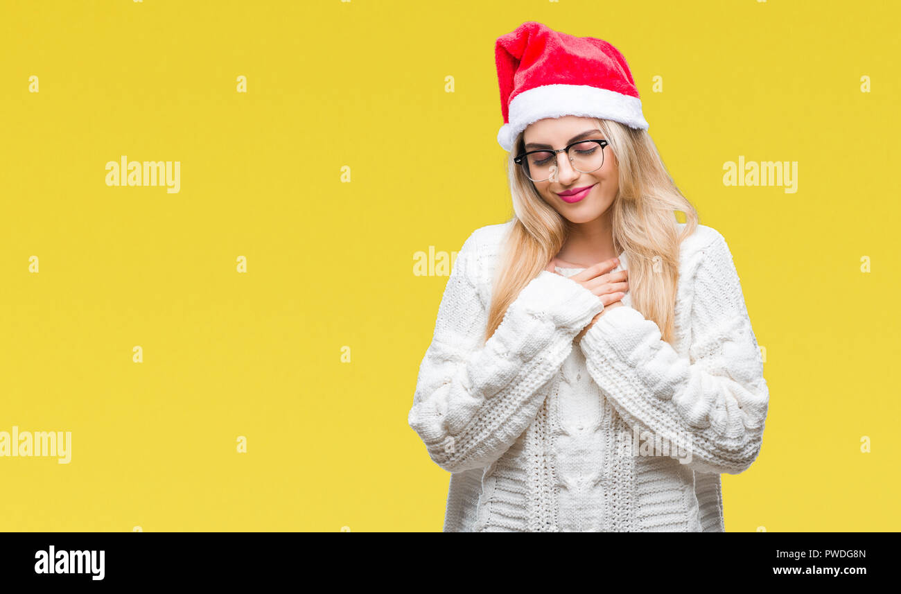 Young Beautiful Blonde Woman Wearing Christmas Hat Over Isolated