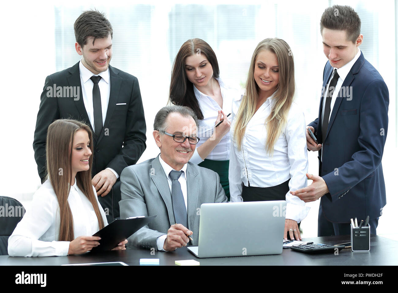 Director and business team looking at laptop screen Stock Photo - Alamy