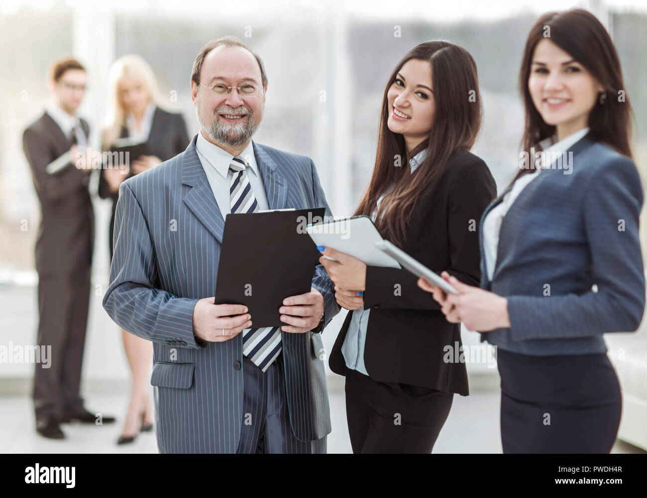 successful businessman and his two assistants with documents on the ...