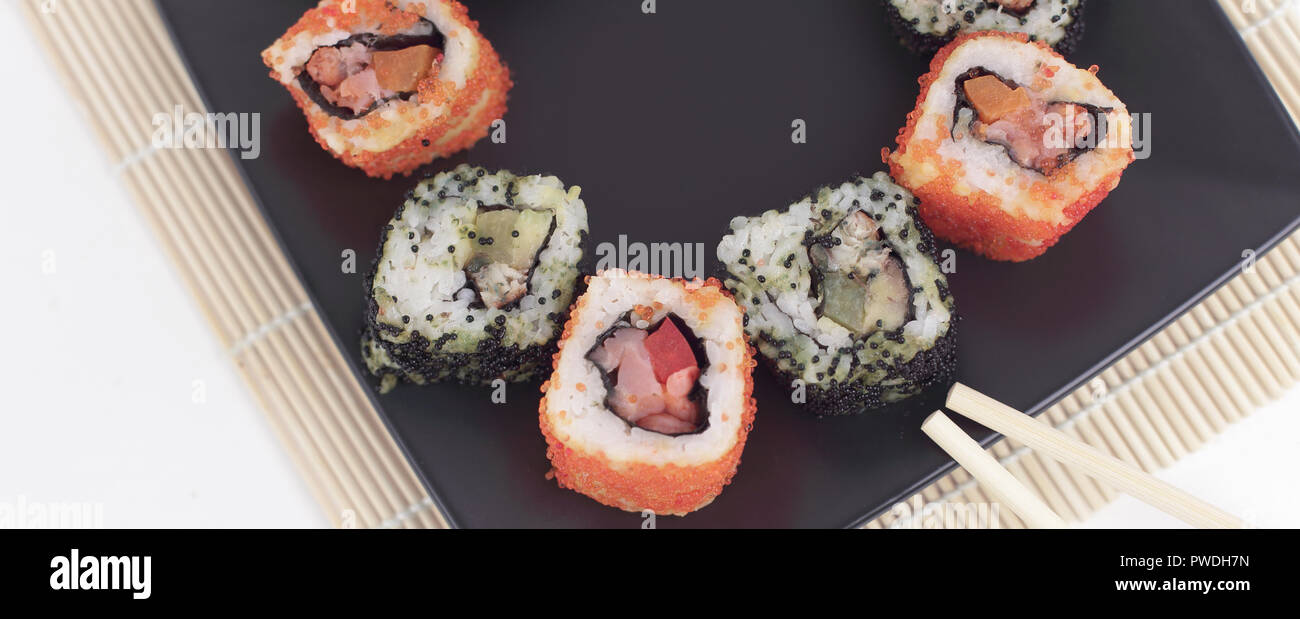 Sushi Set - different types of Maki sushi and chopsticks on a b Stock ...