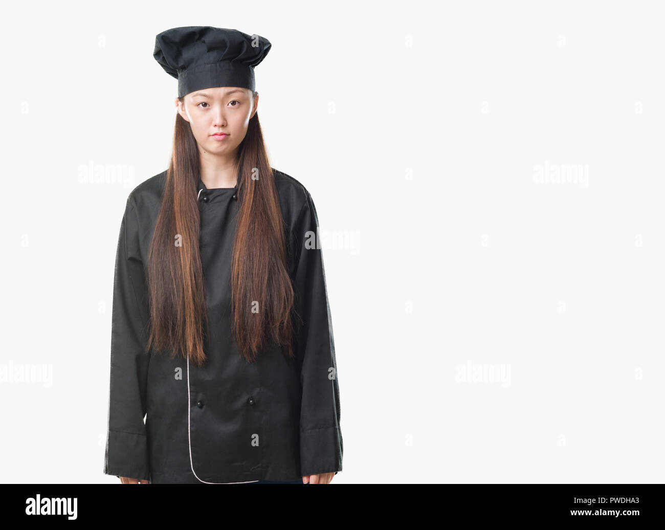 Young Chinese woman over isolated background wearing chef uniform ...
