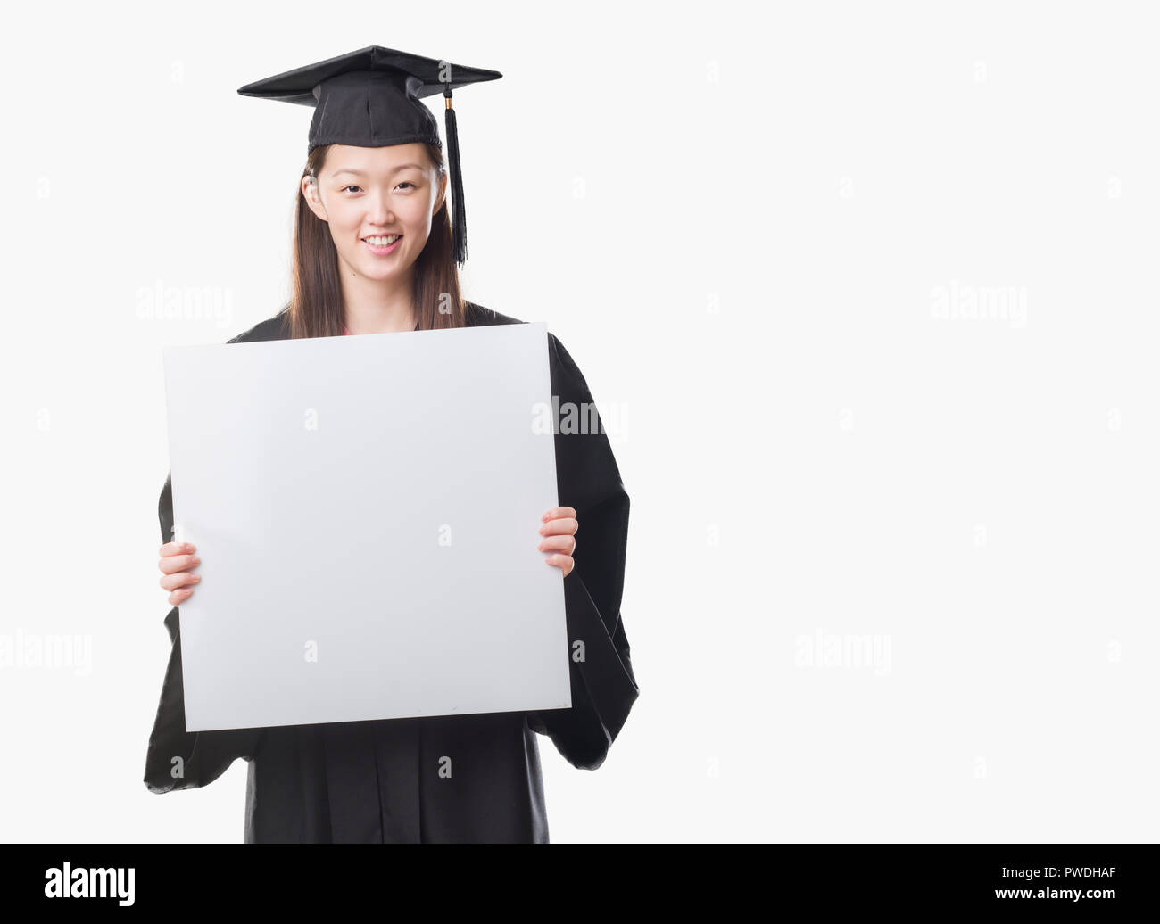 Young Chinese woman wearing graduate uniform holding banner with a ...