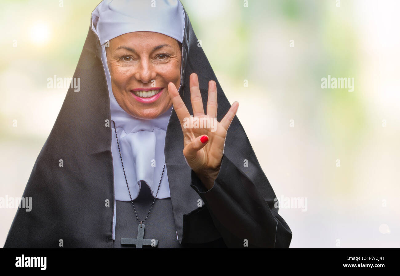 Middle age senior christian catholic nun woman over isolated background ...