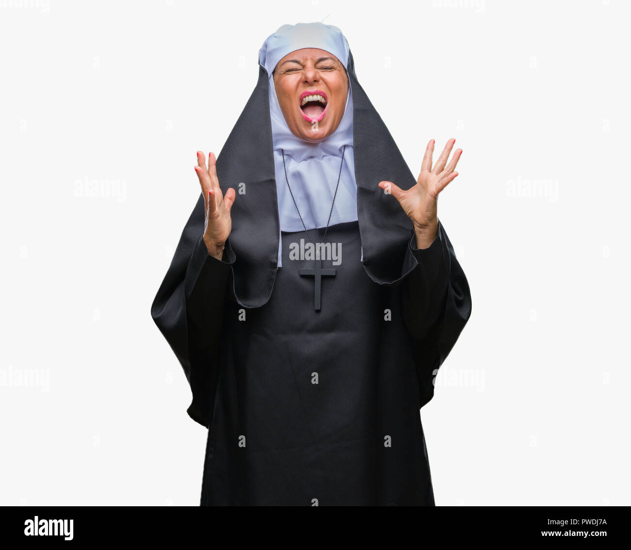 Middle age senior christian catholic nun woman over isolated background ...