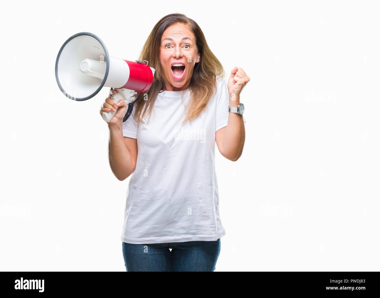 Middle age hispanic woman yelling through megaphone over isolated ...