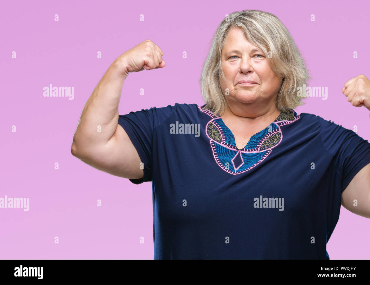 Senior plus size caucasian woman over isolated background showing arms ...