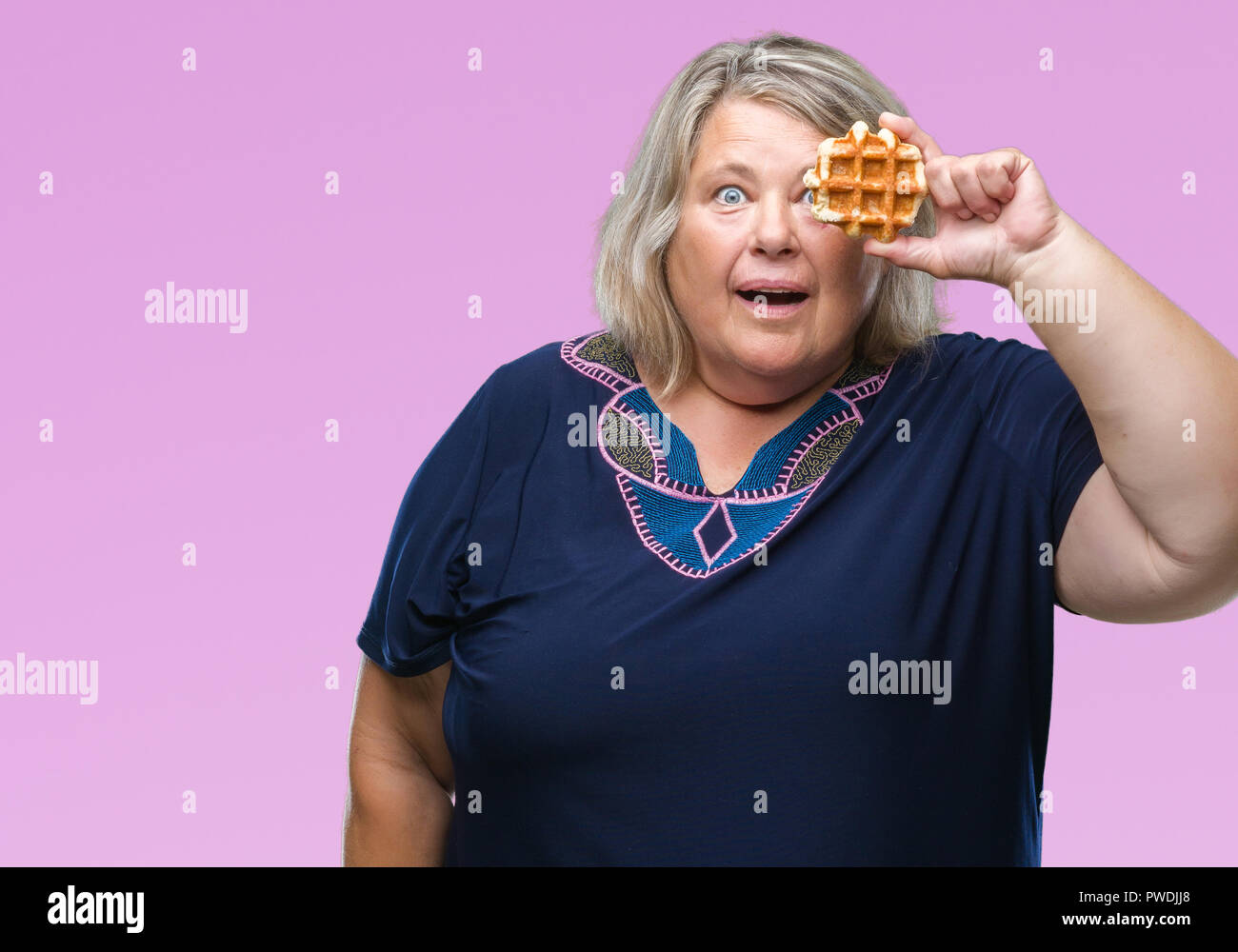 Senior plus size caucasian woman eating waffle over isolated background ...
