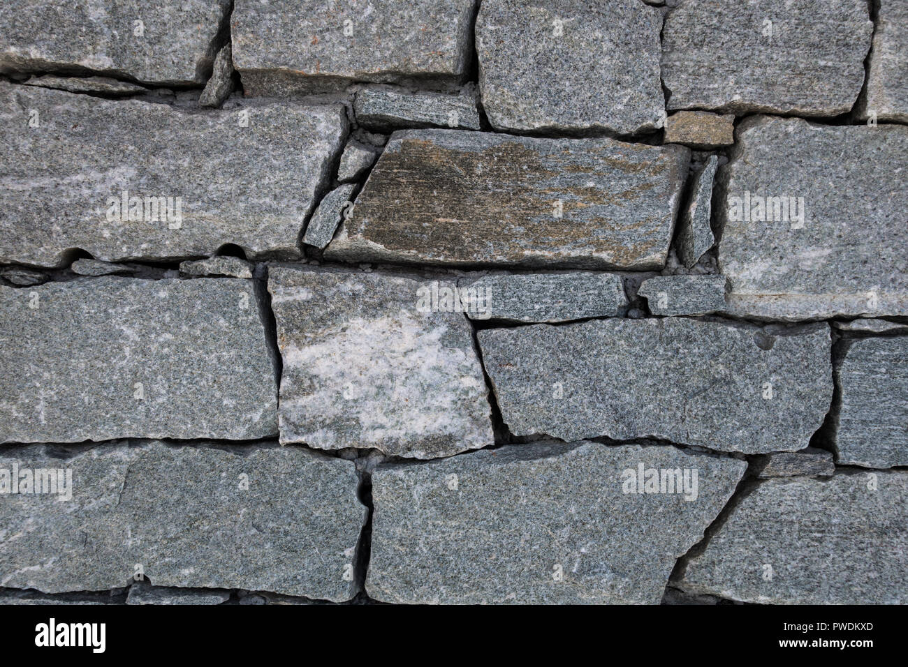 Close-up of granite rock blocks joined together without mortar forming ...