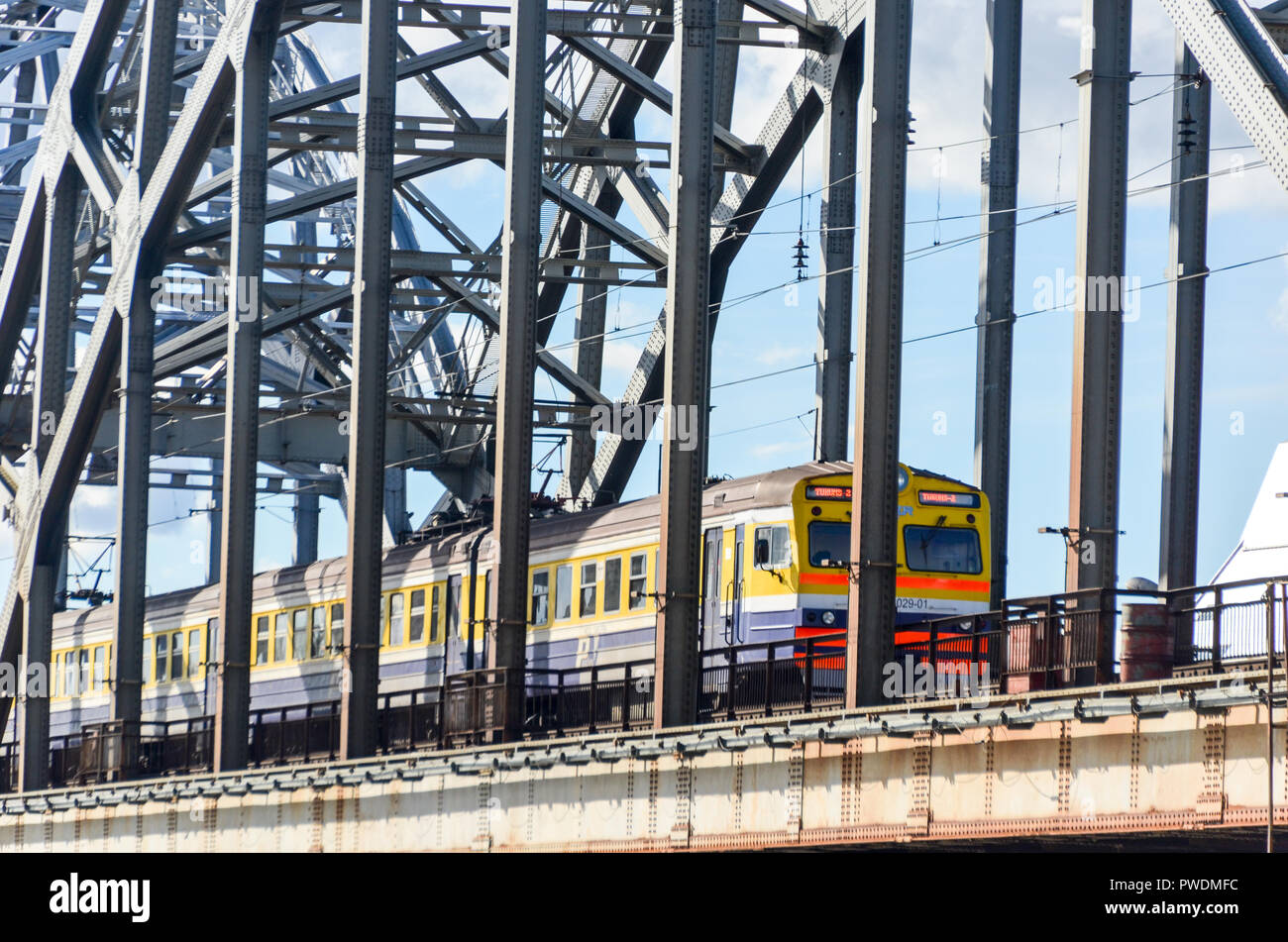 Latvian Railway train passing over the Railway bridge, Riga, Latvia, over the Daugava river ...