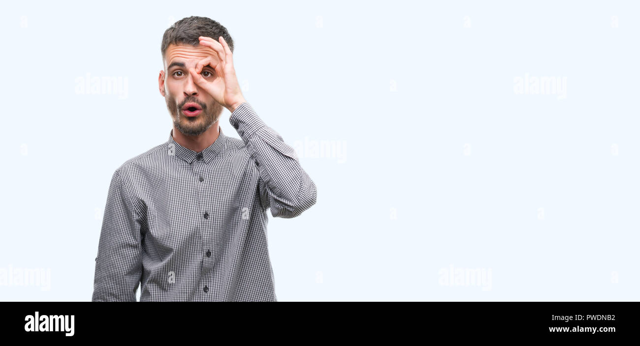 Young hipster man doing ok gesture shocked with surprised face, eye ...