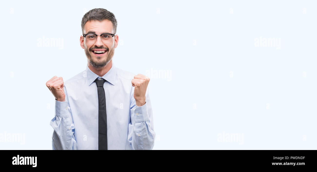 Young business man screaming proud and celebrating victory and success ...