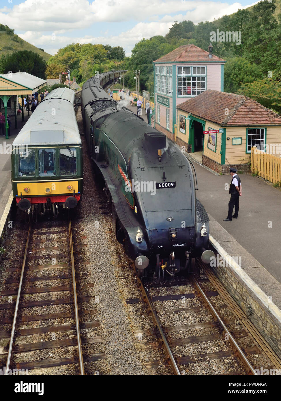 Steam train passing through Corfe Castle station on the Swanage Railway ...