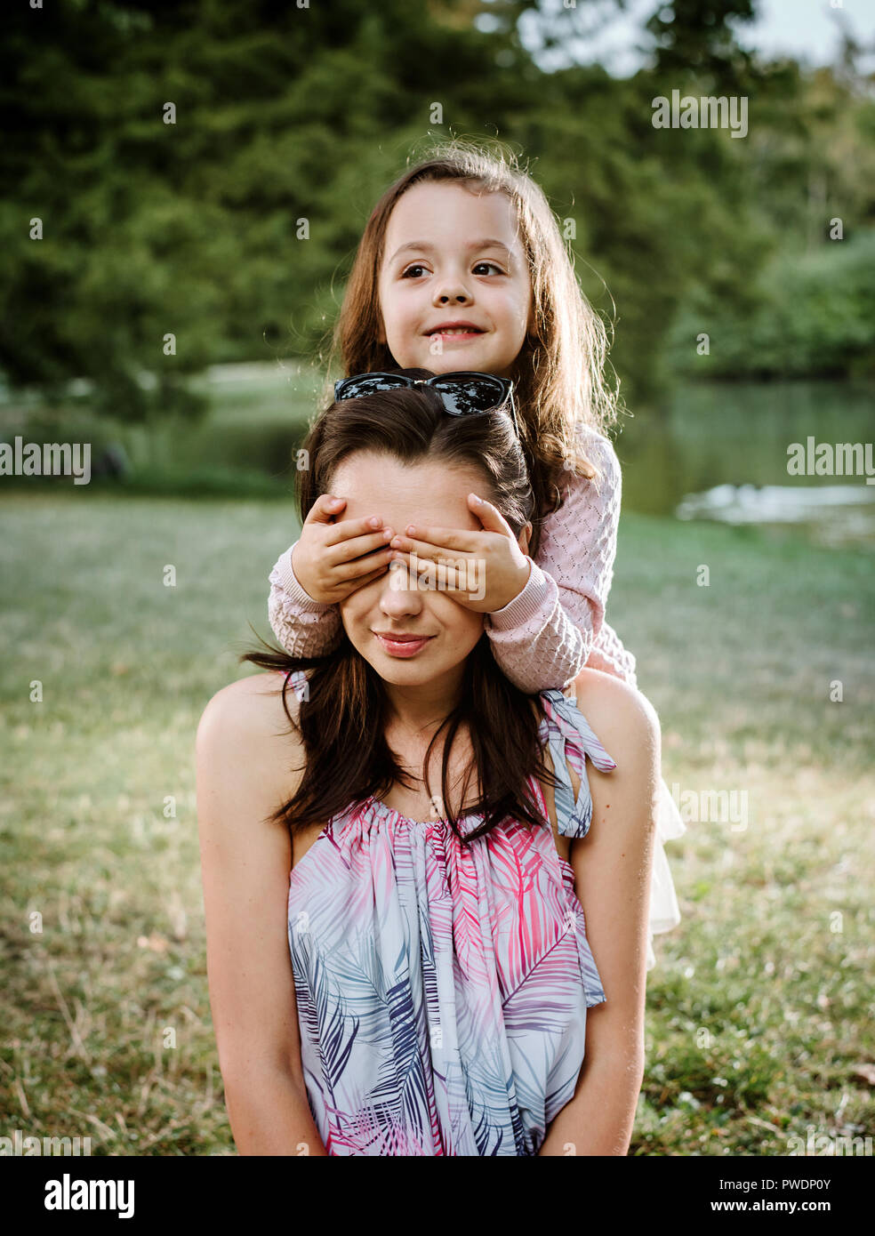 Mother and daughter having a great fun in the summer park Stock Photo ...