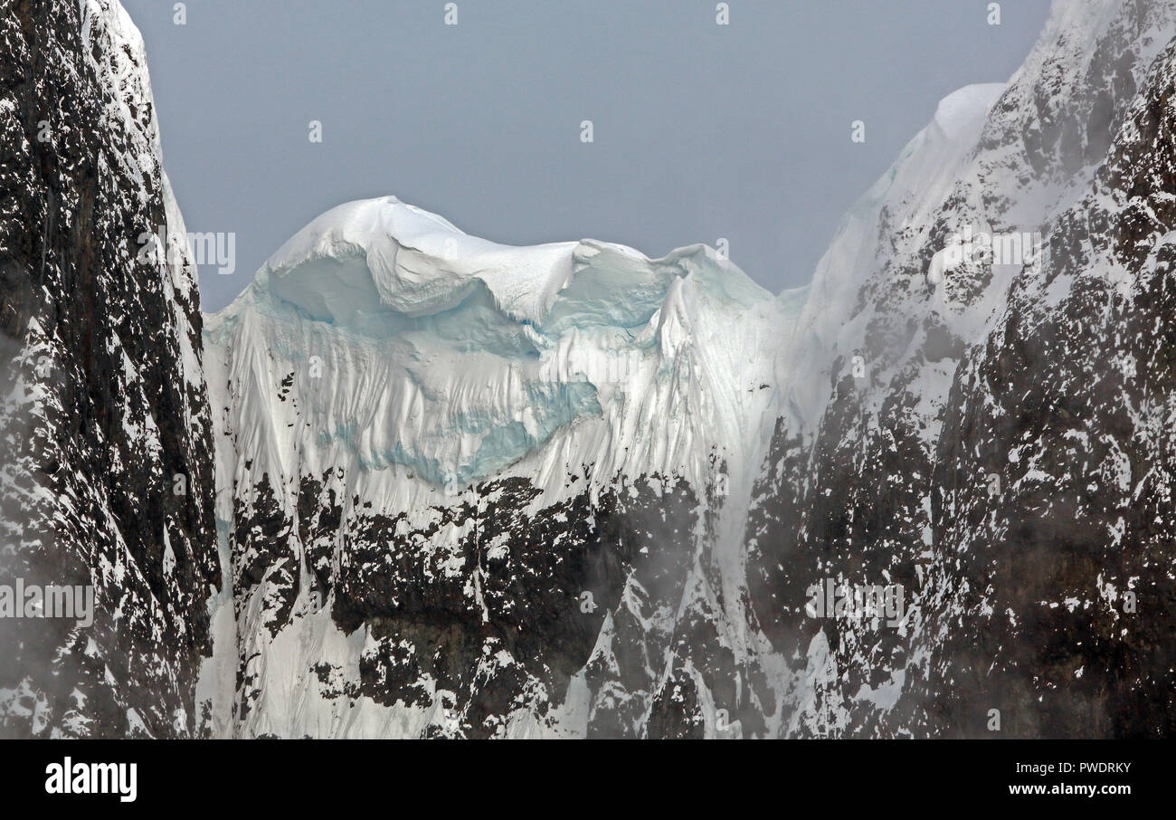 huge snow cornice between two mountain peaks, Antarctica Stock Photo ...