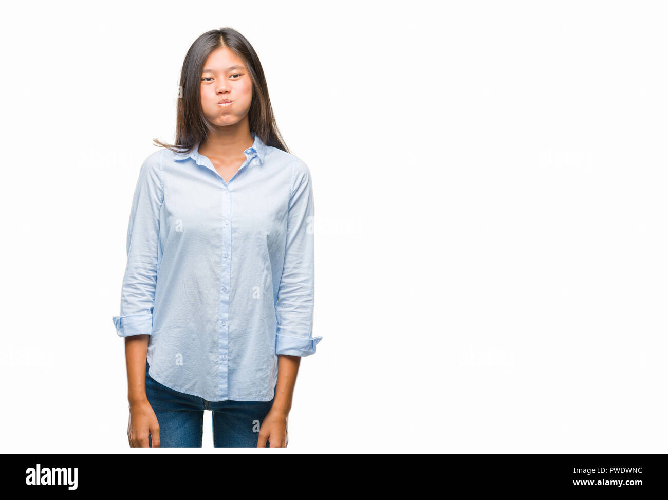 Young asian business woman over isolated background puffing cheeks with ...