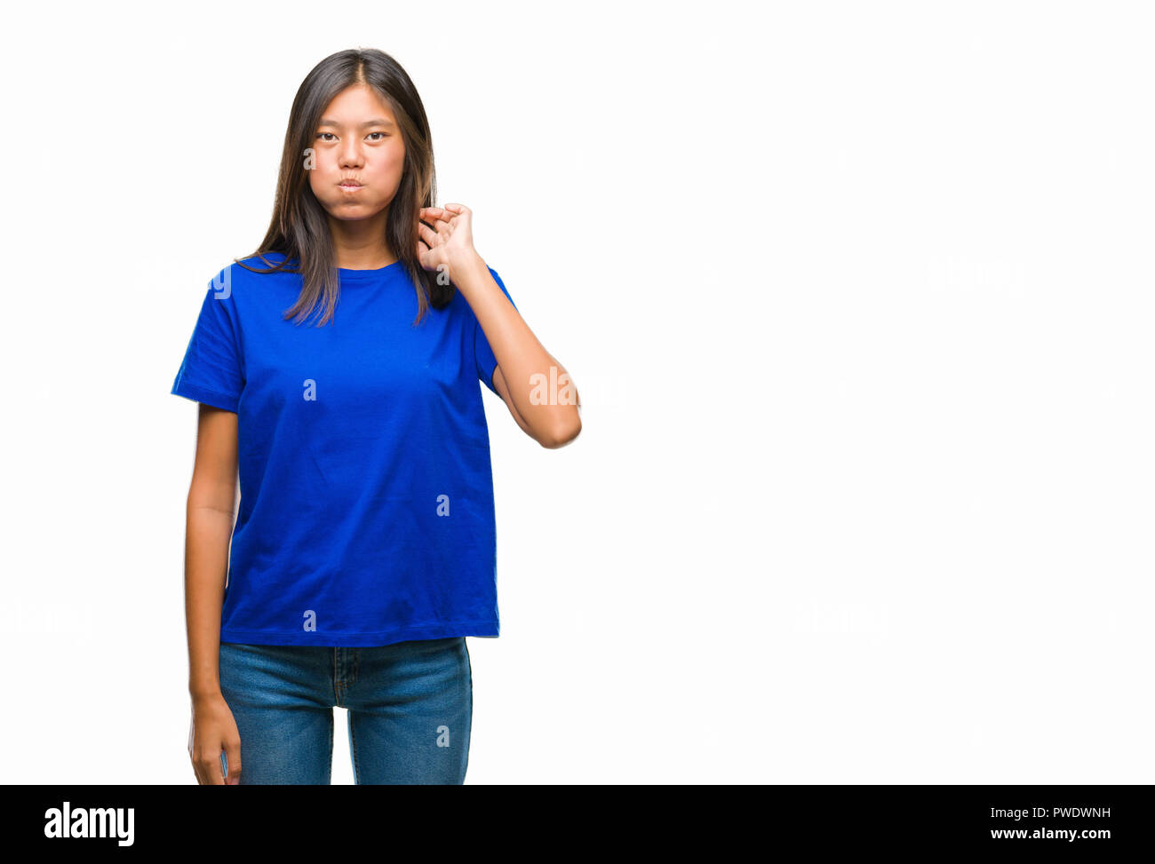 Young asian woman over isolated background puffing cheeks with funny ...
