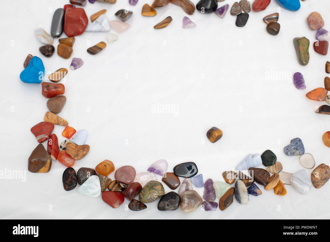 Bunch of colorful stones scattered against white background Stock Photo ...