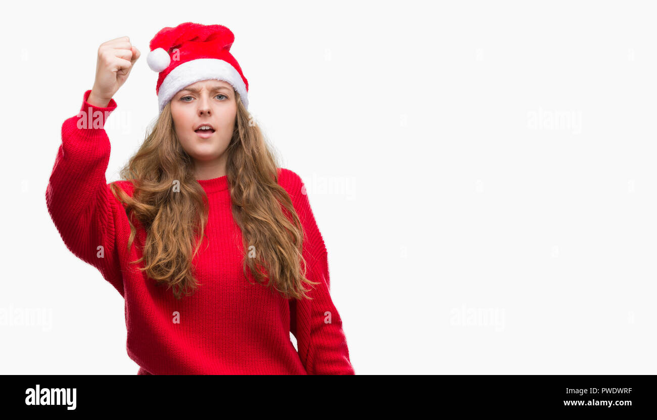Young blonde woman wearing santa claus hat annoyed and frustrated ...