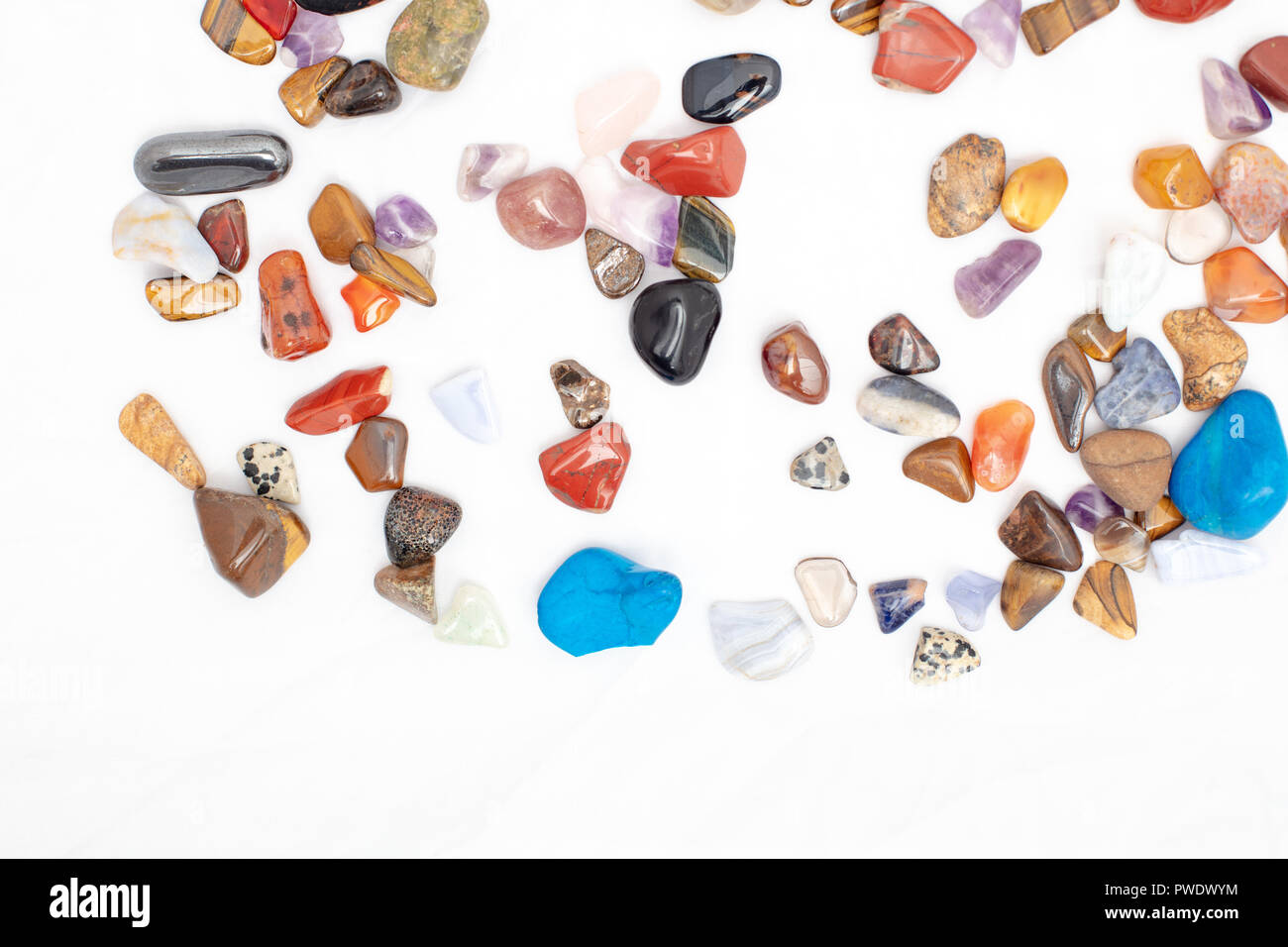 Bunch of colorful stones scattered against white background Stock Photo ...