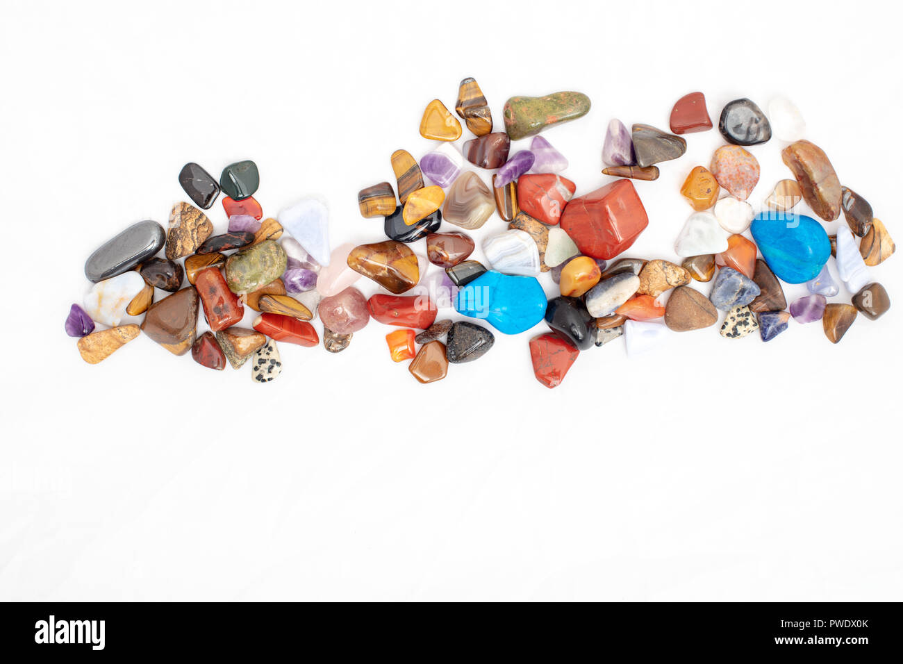 Bunch of colorful stones scattered against white background Stock Photo ...