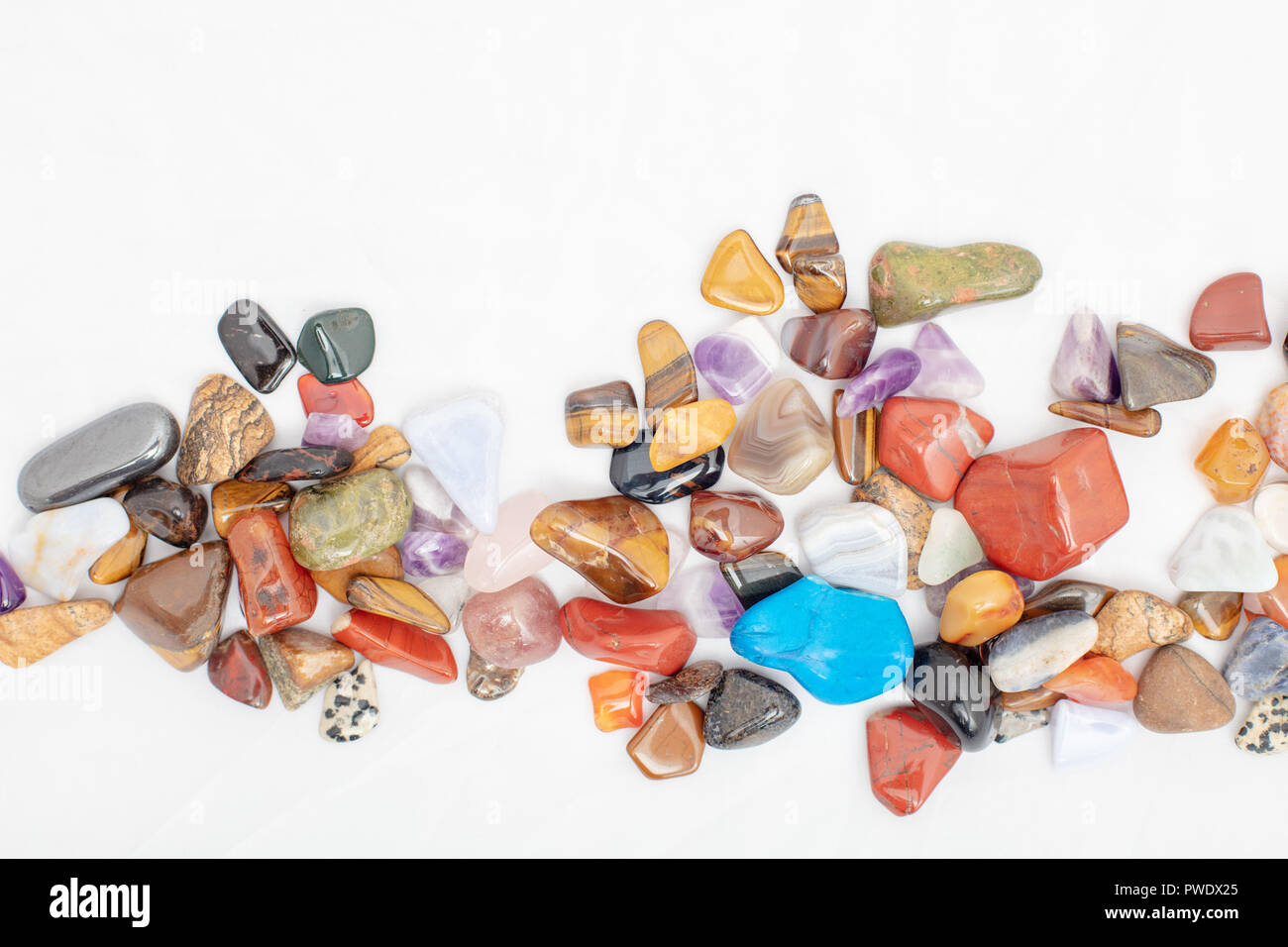 Bunch of colorful stones scattered against white background Stock Photo ...