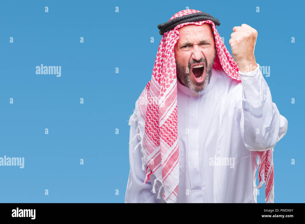 Senior arab man wearing keffiyeh over isolated background angry and mad ...