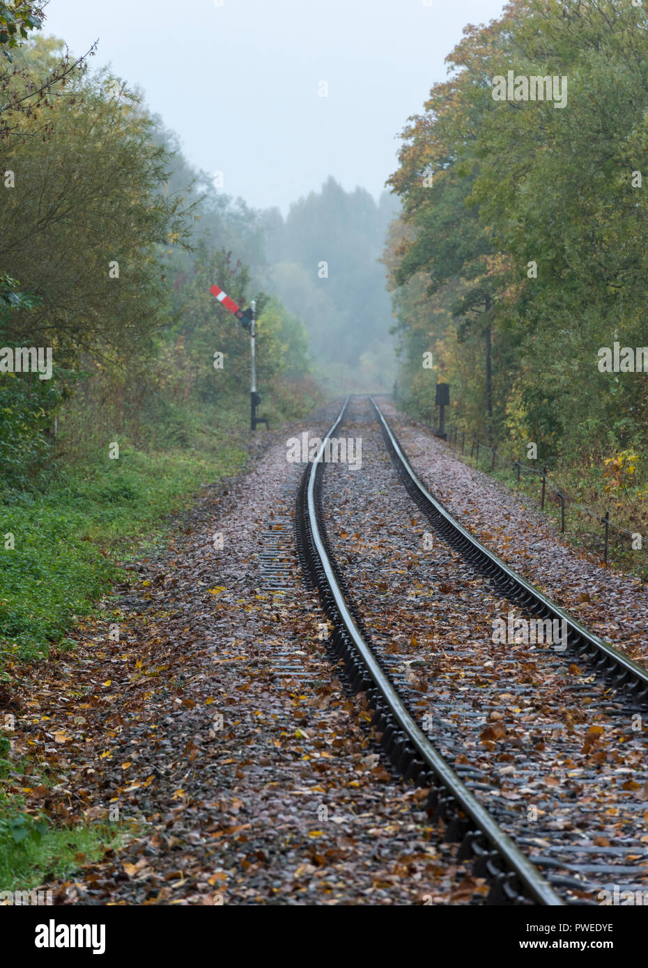 an old preserved railway lines with a semaphore signal on a single line ...