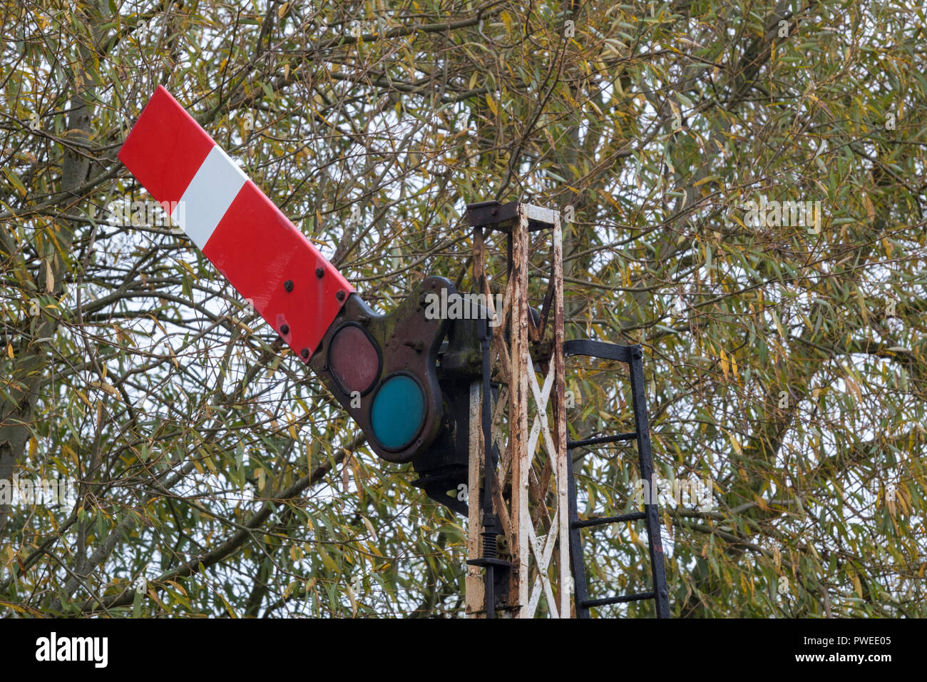 an old fashioned restored railway enamel semaphore stop signal at the ...