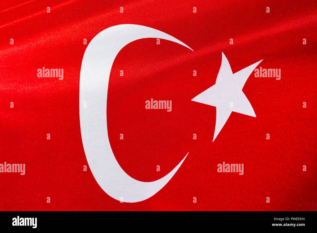 A large red and white Turkish flag blowing in the wind on a sunny day ...