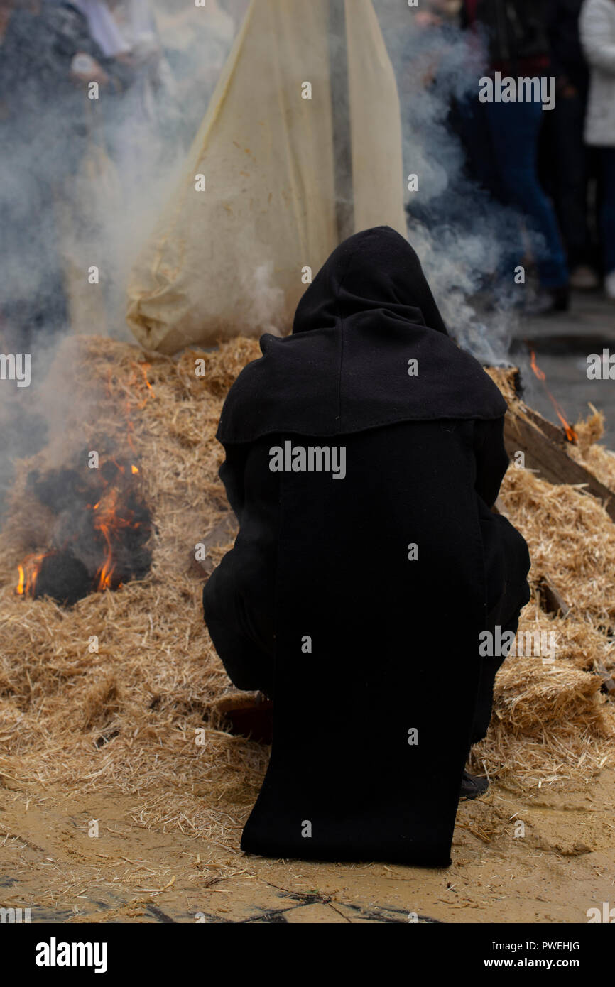 Man wearing a medieval costume is building a campfire Stock Photo - Alamy