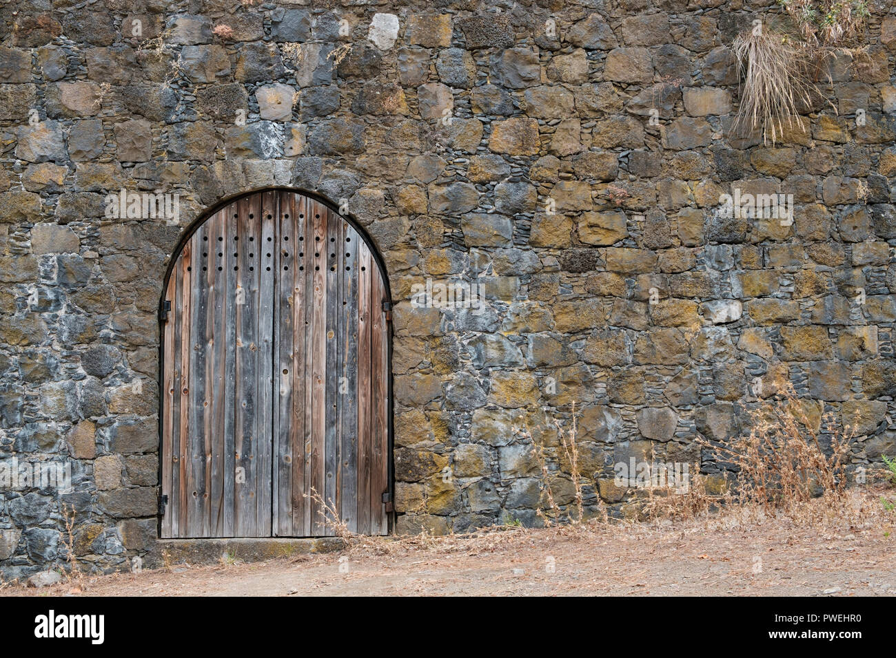 wooden door / vintage wood gate on natural stone wall Stock Photo - Alamy