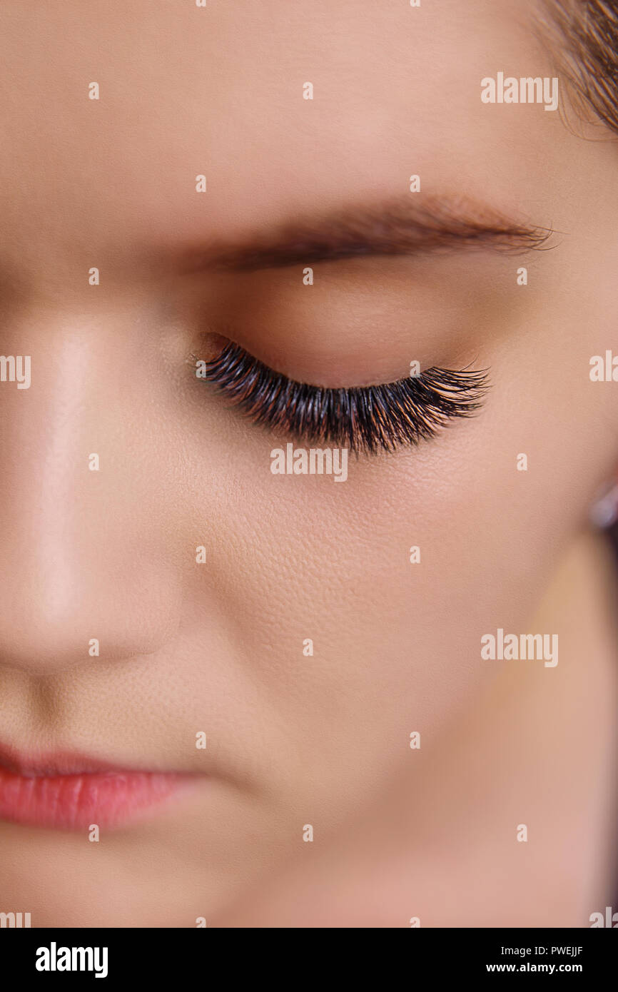 Eyelash Extension Procedure. Woman Eye with Long Eyelashes. Close up ...