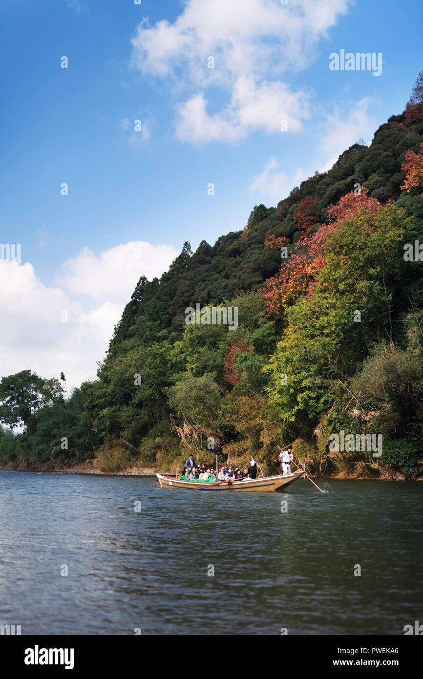 People enjoying a sightseeing ride on Hozugawa river boat cruise ...