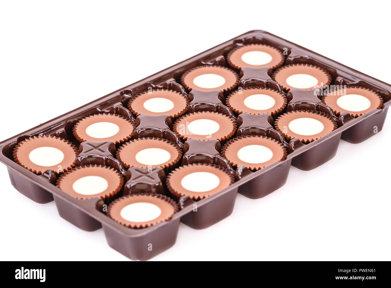 Round chocolate in plastic box on white background Stock Photo - Alamy