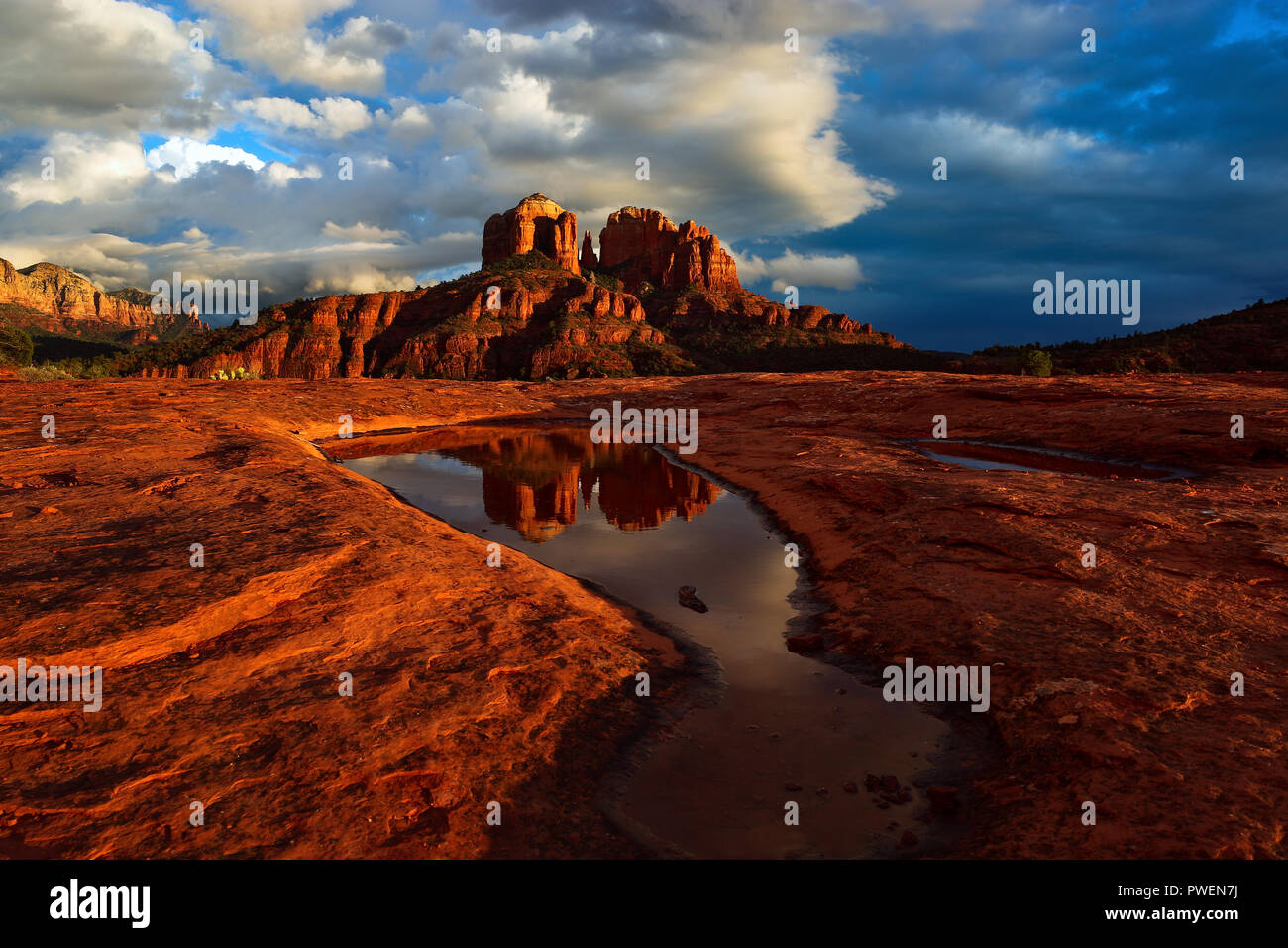 Cathedral Rock in Sedona, Arizona reflects in shallow red rock pools ...