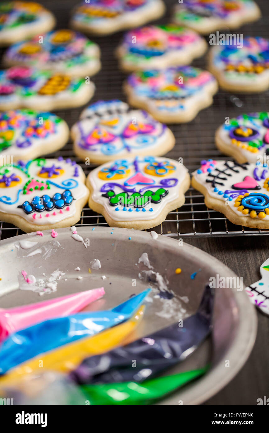 Sugar cookies in shape of sugar skull decorated with colorful royal ...