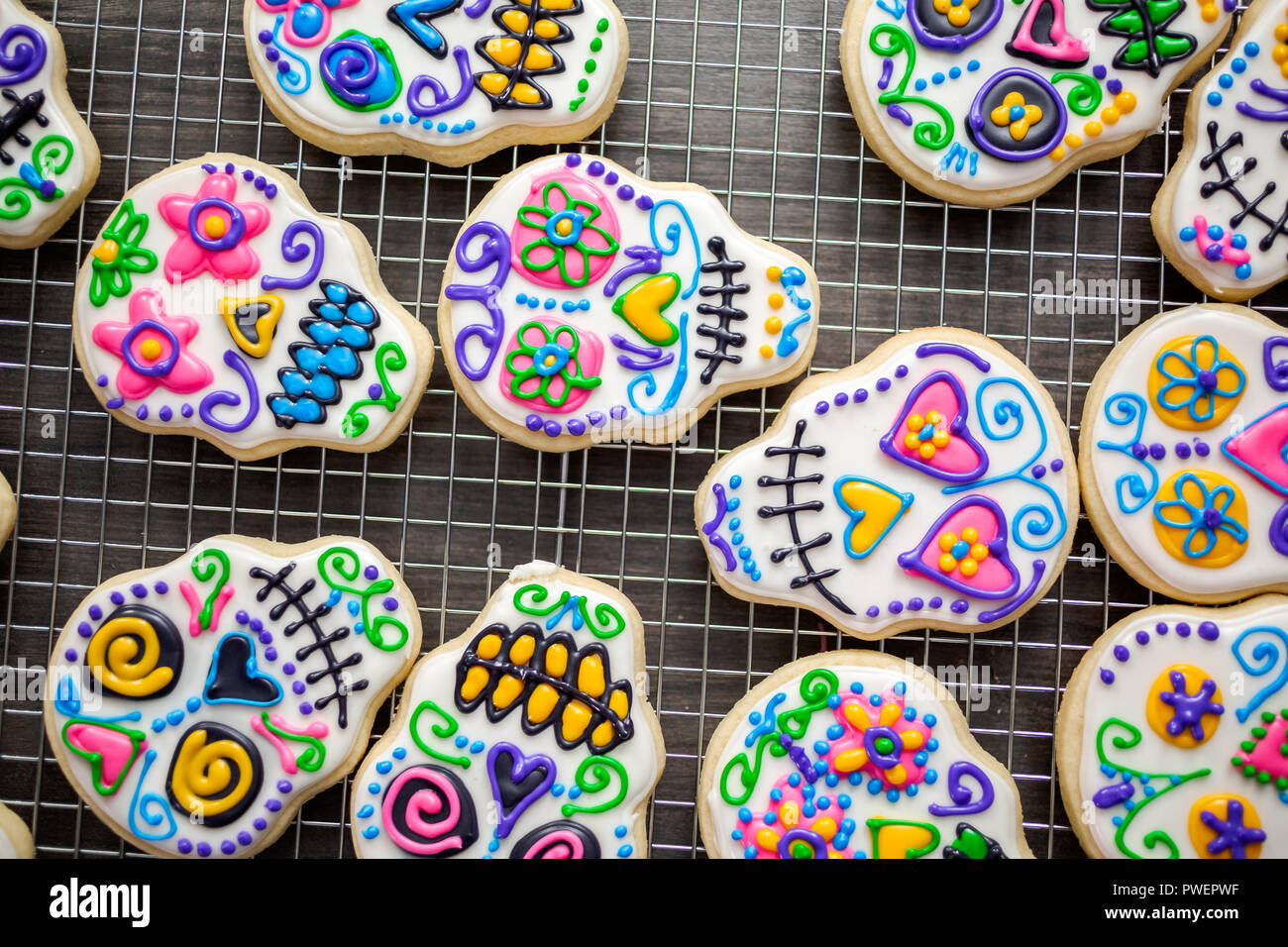 Sugar cookies in shape of sugar skull decorated with colorful royal ...