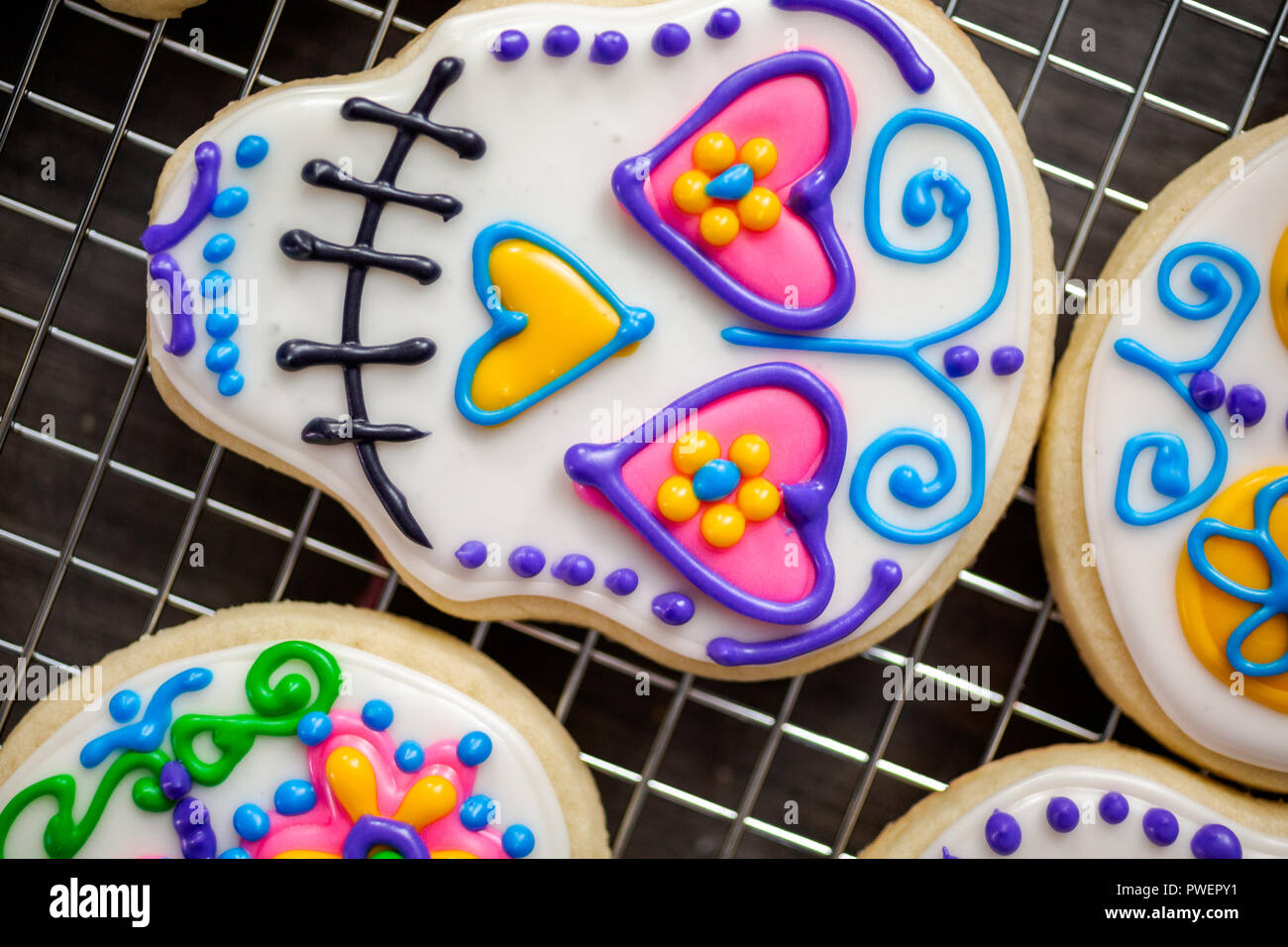Sugar cookies in shape of sugar skull decorated with colorful royal ...