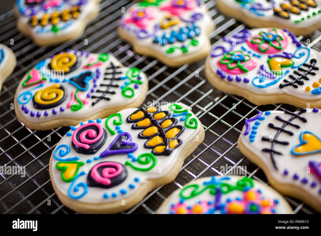 Sugar cookies in shape of sugar skull decorated with colorful royal ...