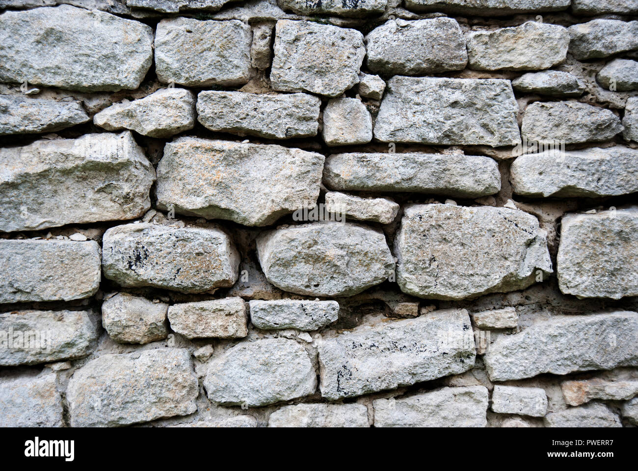 Gray slate wall stone background or texture.Surface with light ...