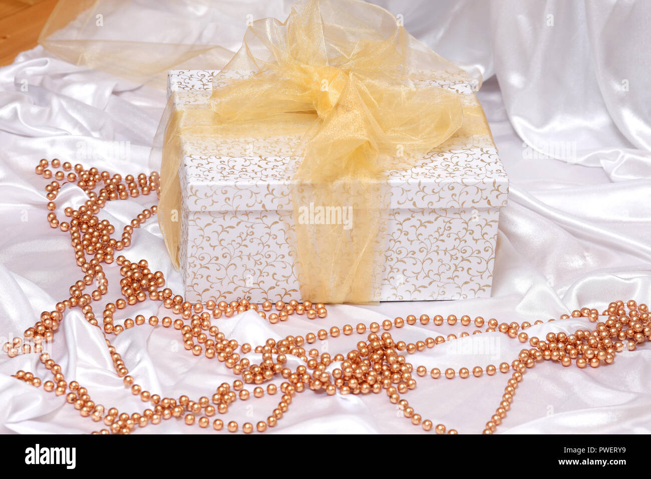 White box with golden bow isolated on white background. Luxury package ...