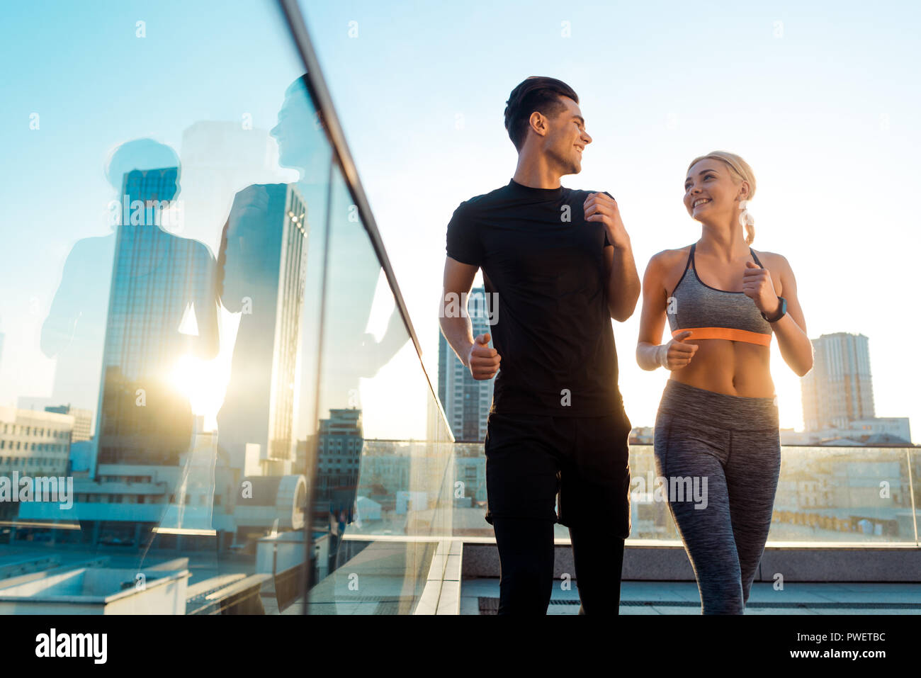 Athletic couple running together sunrise hi-res stock photography and ...