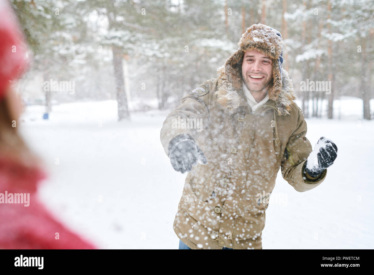 Waist up portrait of handsome young man laughing happily while enjoying ...