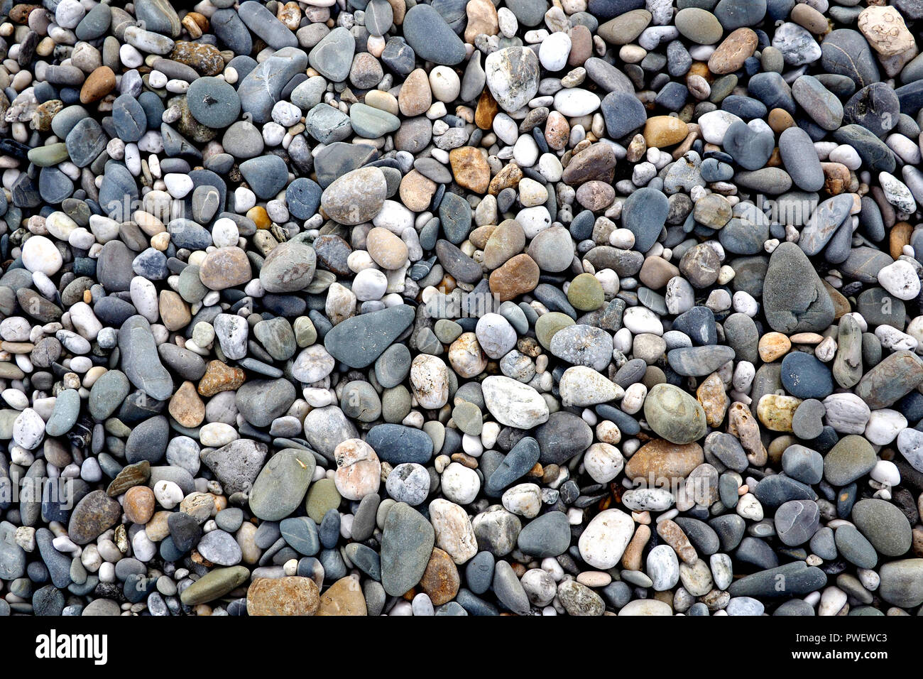 Textured pebbles on a beach Stock Photo - Alamy