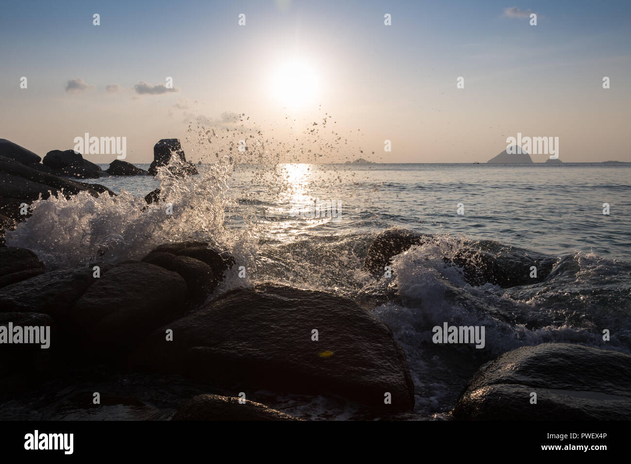 Sea waves lash line impact rock on the beach Stock Photo - Alamy