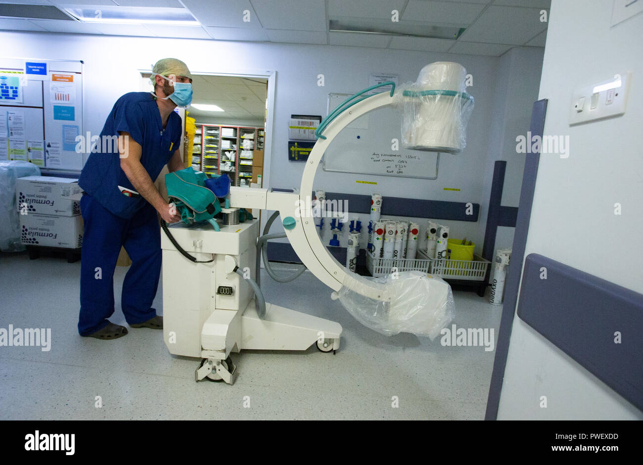 Hospital theatre technician pushes an x ray machine hi-res stock ...