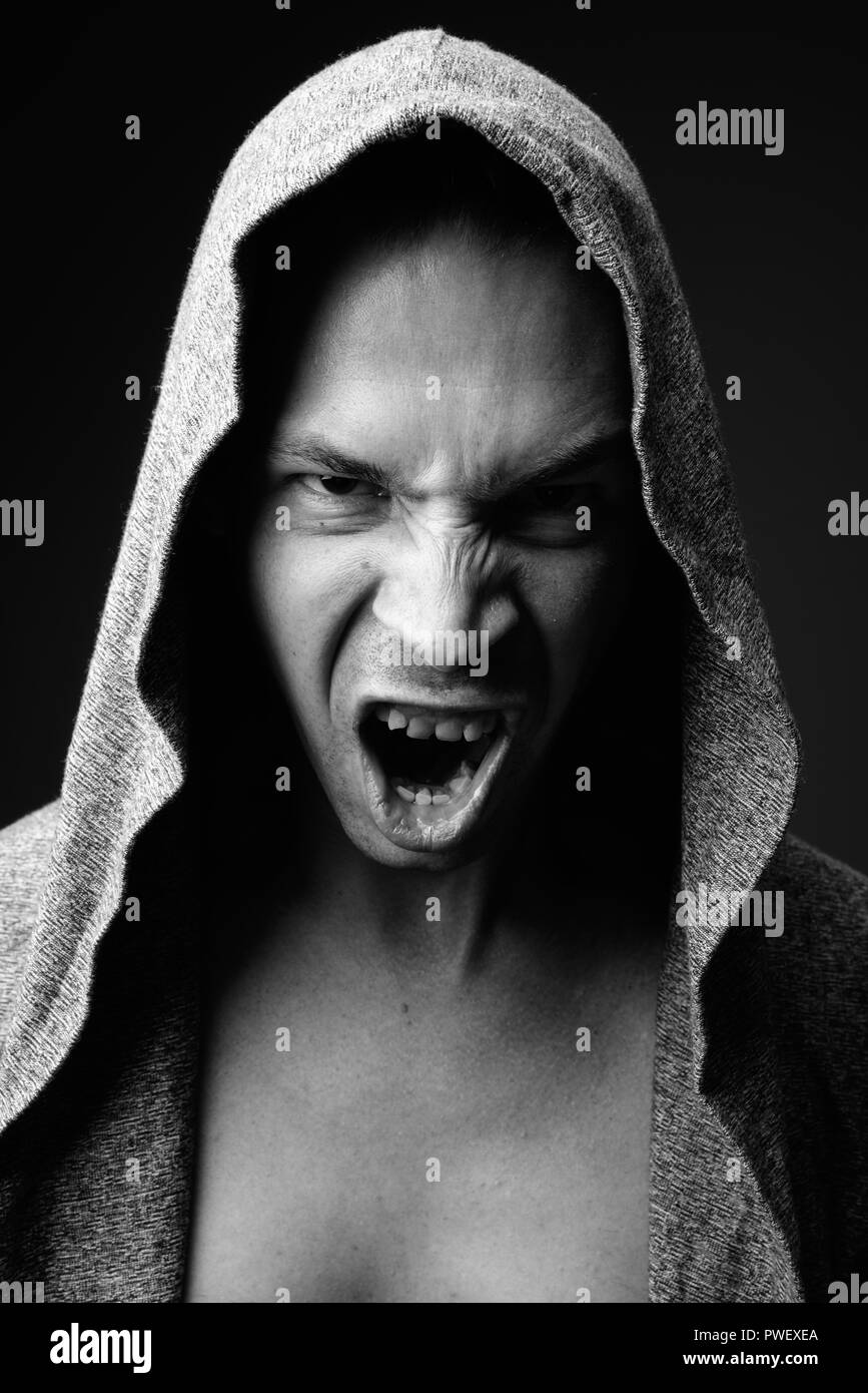 Rebellious man against black background in black and white Stock Photo ...