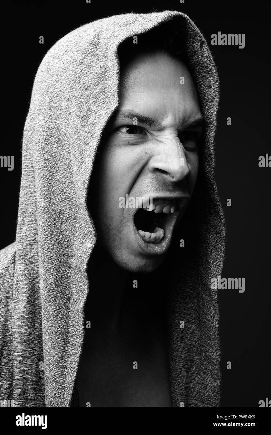 Rebellious man against black background in black and white Stock Photo ...